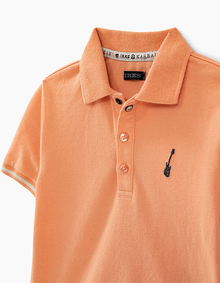 Boys’ faded orange polo shirt with printed back